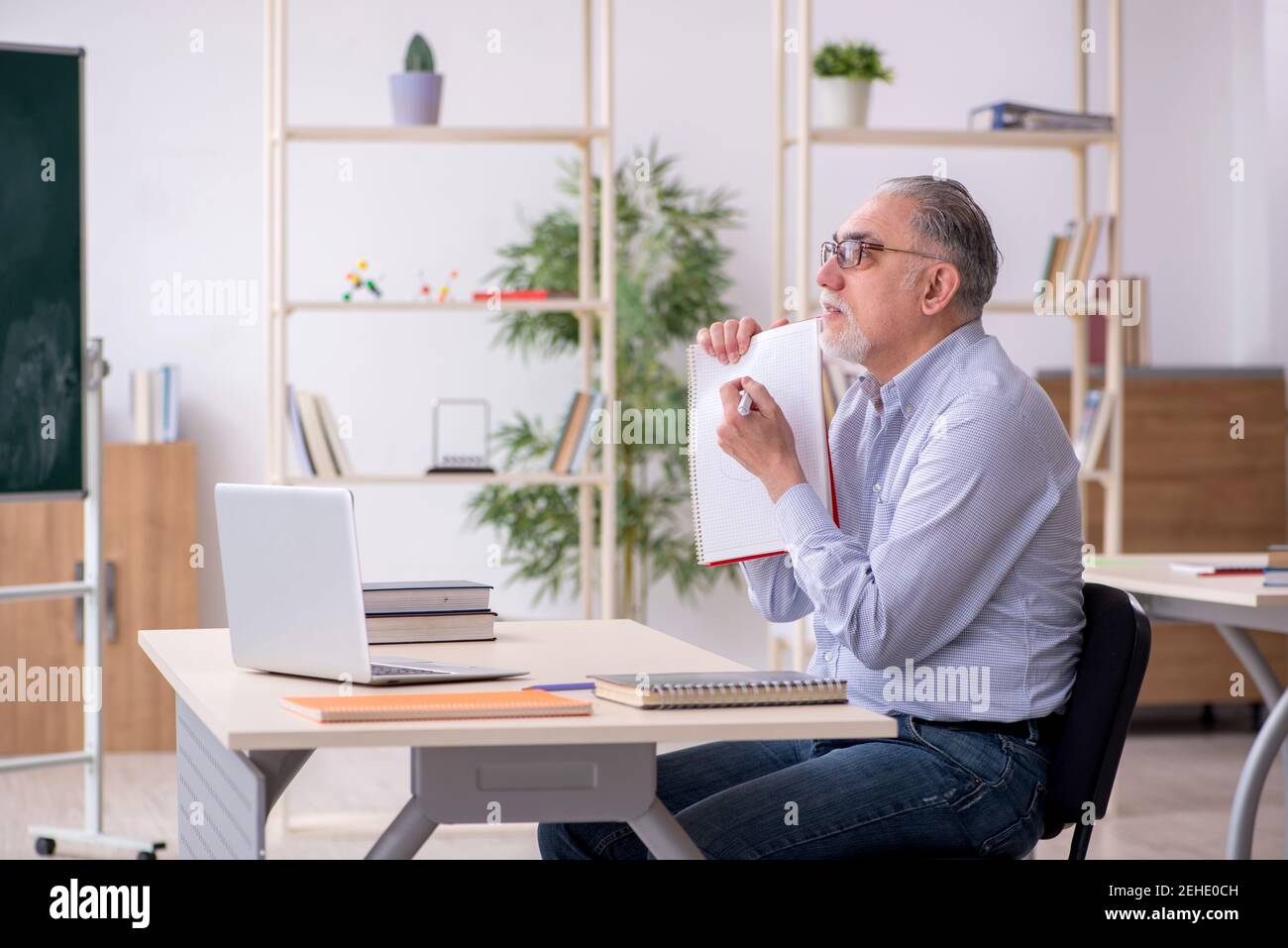 Old male teacher in the school classroom Stock Photo - Alamy