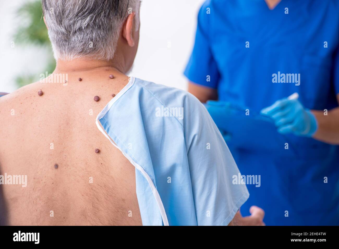 Old man visiting male doctor dermatologist Stock Photo - Alamy