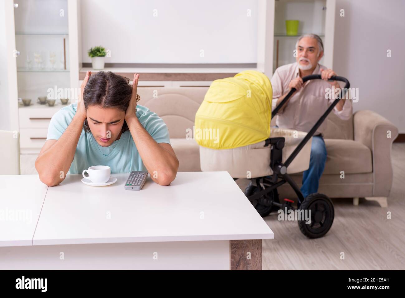 Old grandfather looking after newborn at home Stock Photo - Alamy