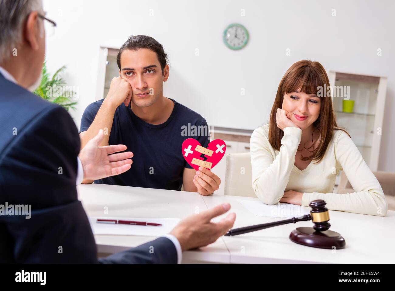 Old judge and young couple in divorcing concept Stock Photo - Alamy