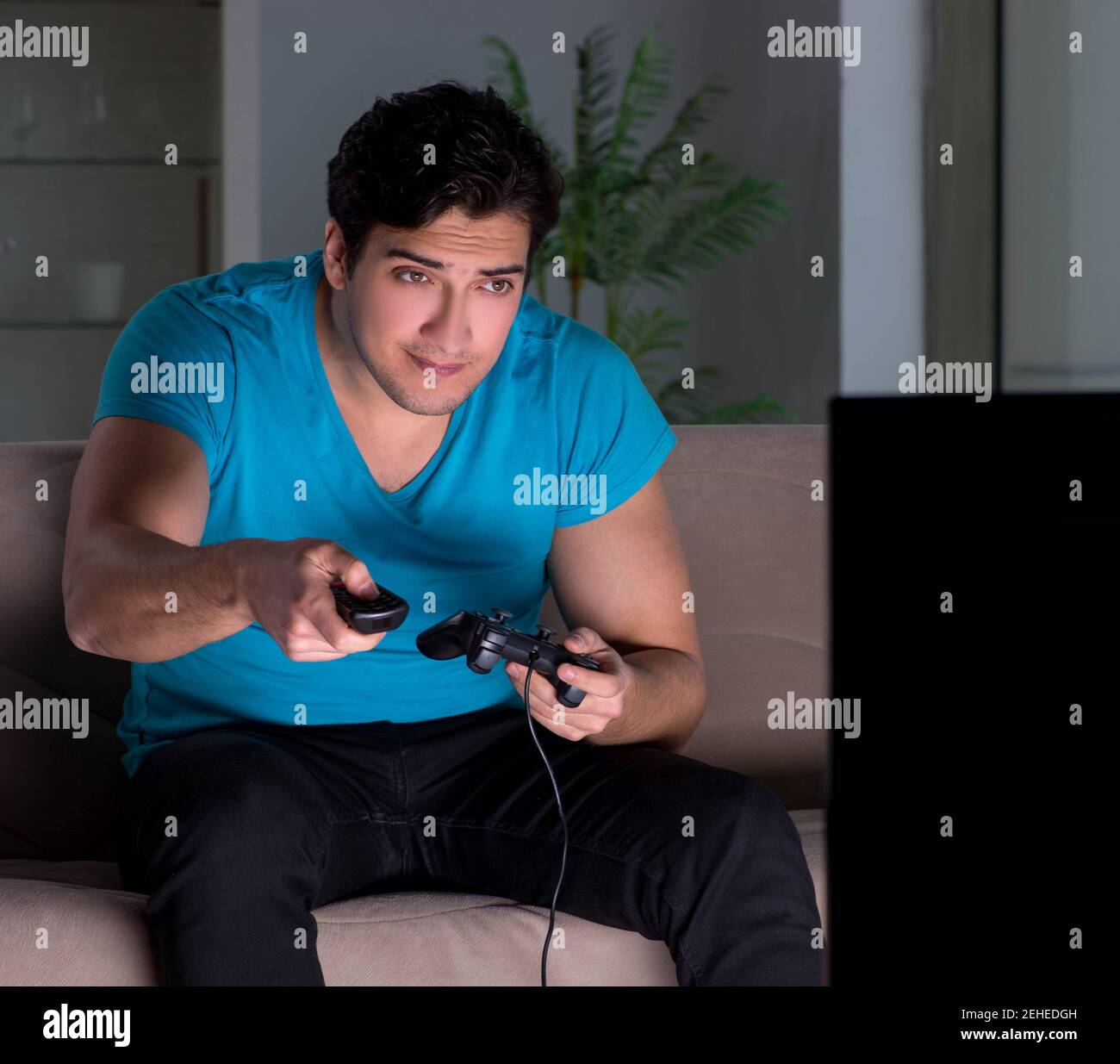 The young man playing computer games late at night Stock Photo - Alamy