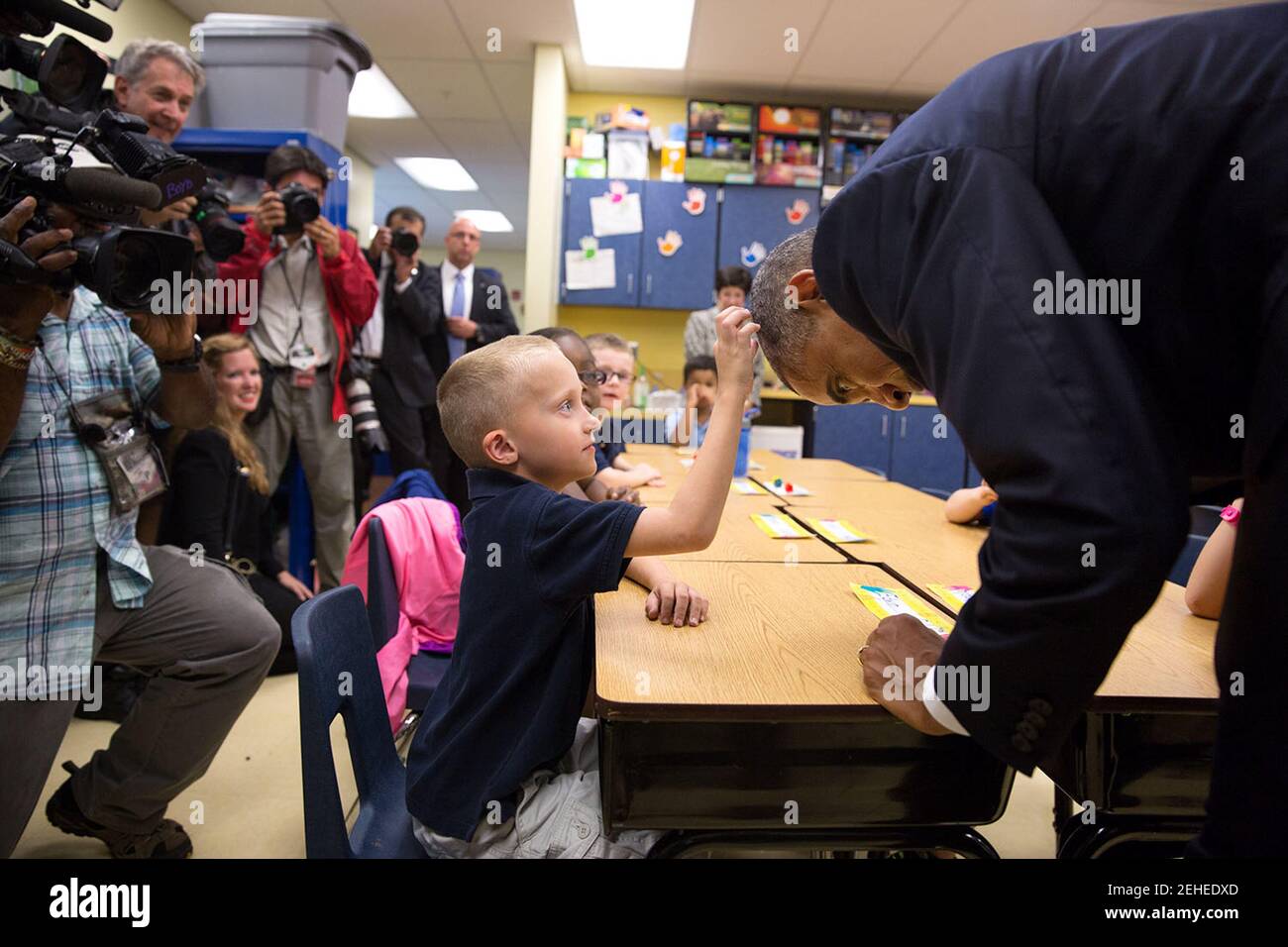 President Barack Obama allows first grader Edwin Caleb to touch his ...