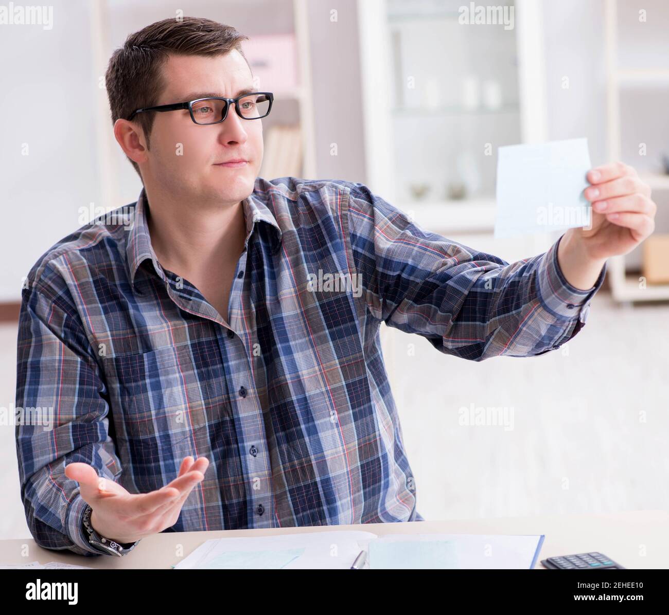 The young man frustrated at his house and tax bills Stock Photo - Alamy