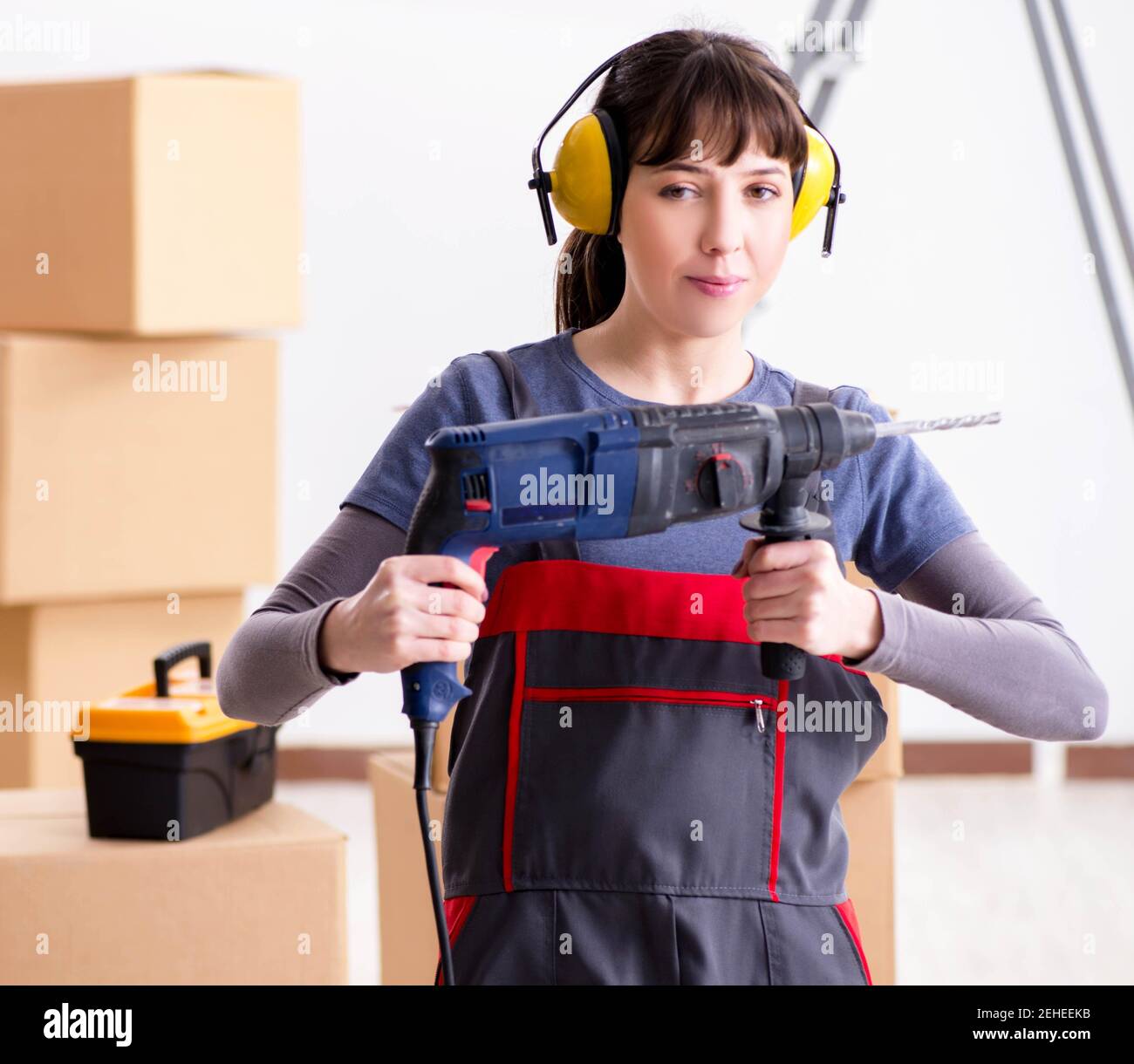 The woman contractor with hand drill at construction site Stock Photo ...