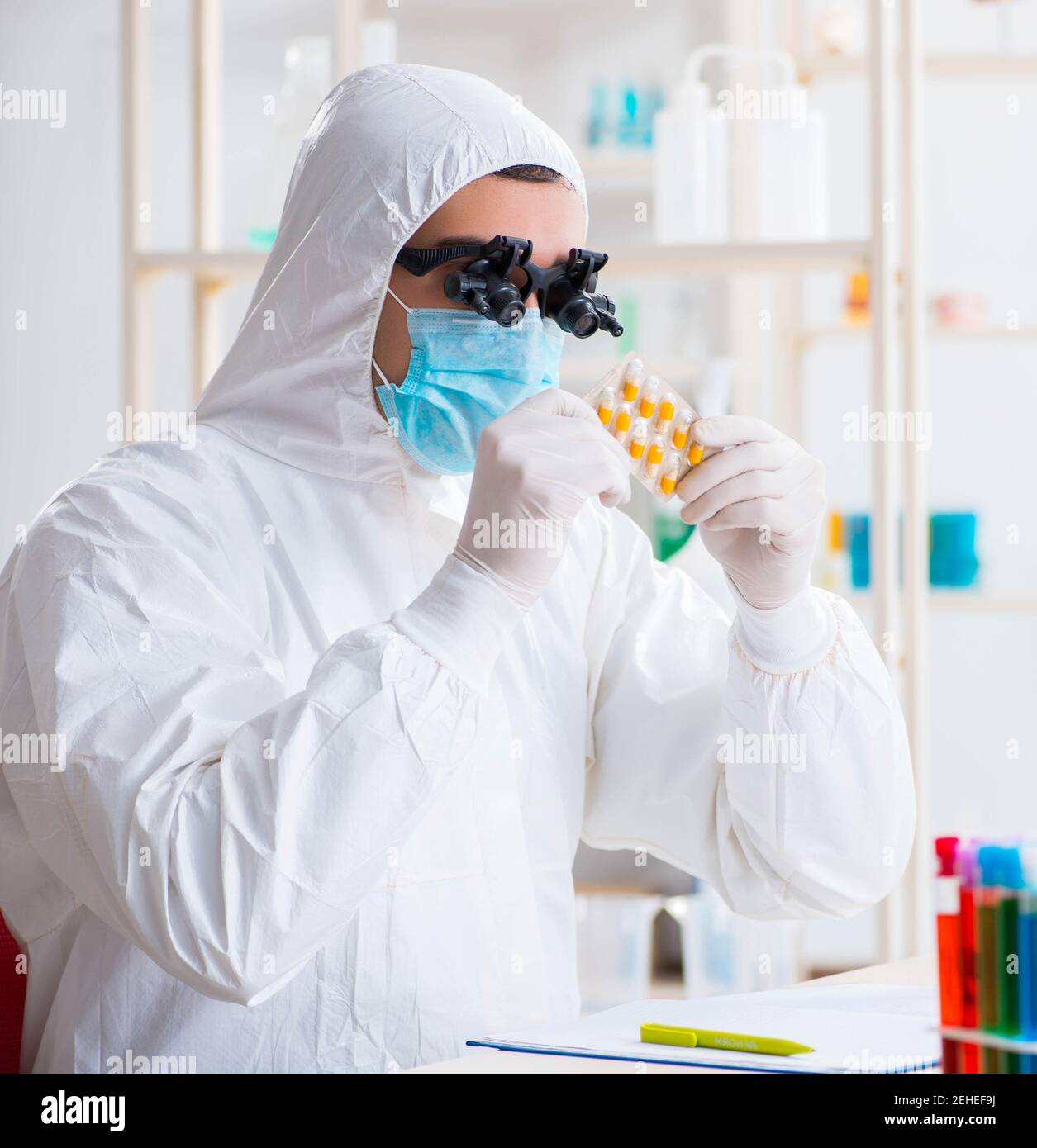 The drug synthesis concept with chemist working in research lab Stock ...