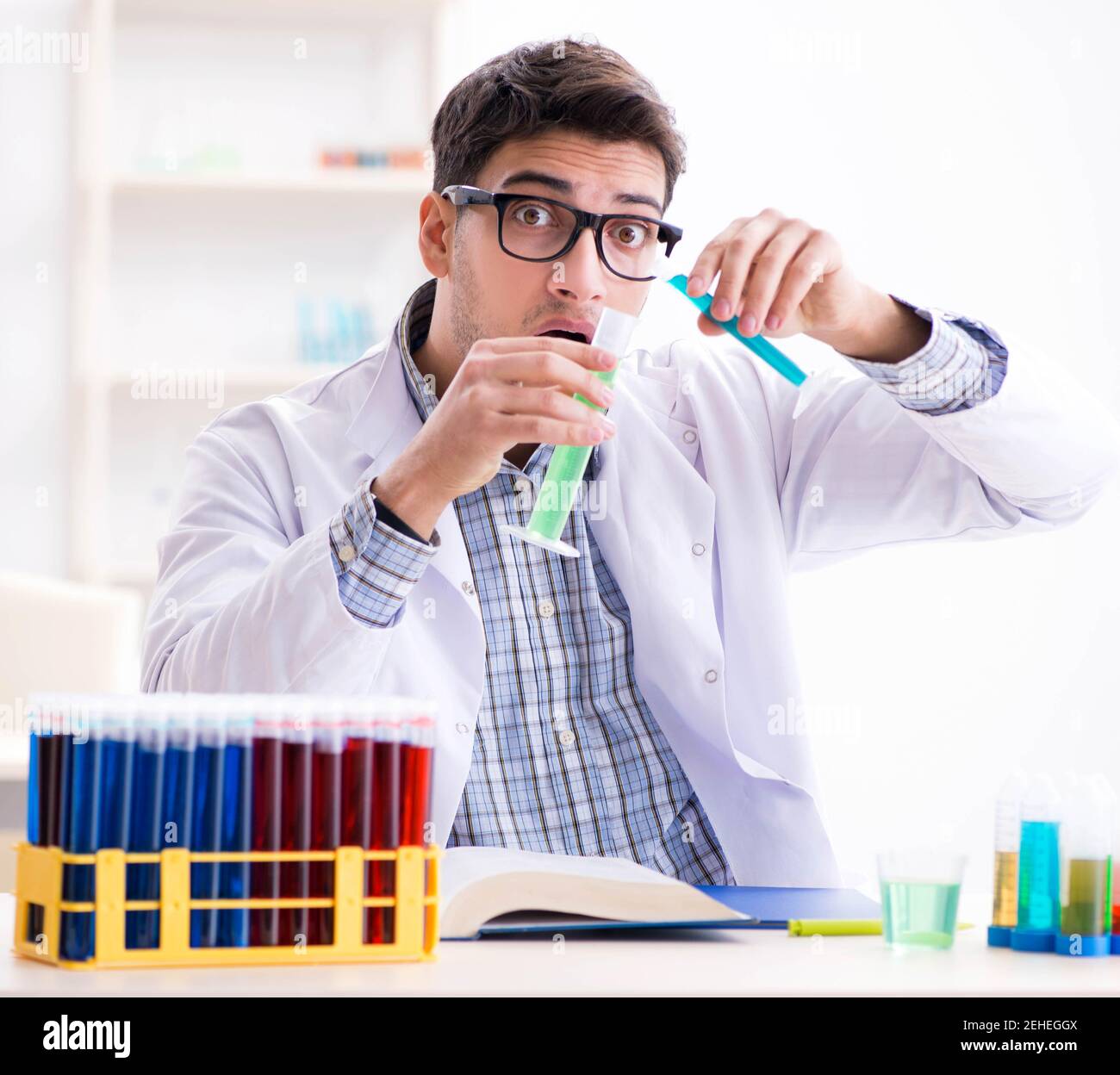 Chemistry student doing chemical experiments at classroom activity ...