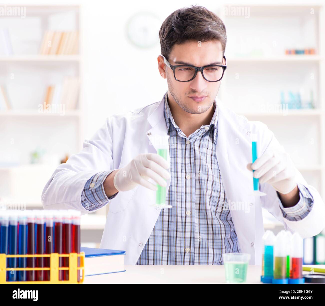 Chemistry student doing chemical experiments at classroom activity ...
