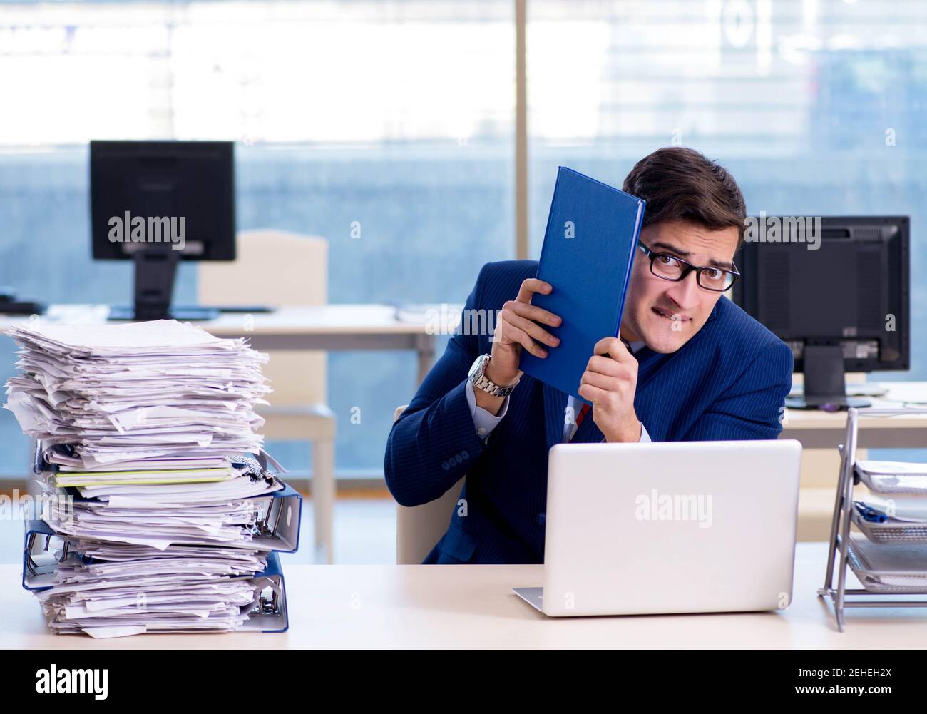 The businessman workaholic struggling with pile of paperwork Stock ...