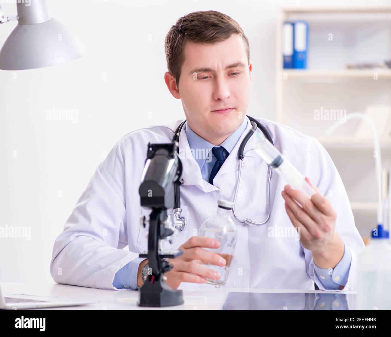The male doctor looking at lab results in hospital Stock Photo - Alamy