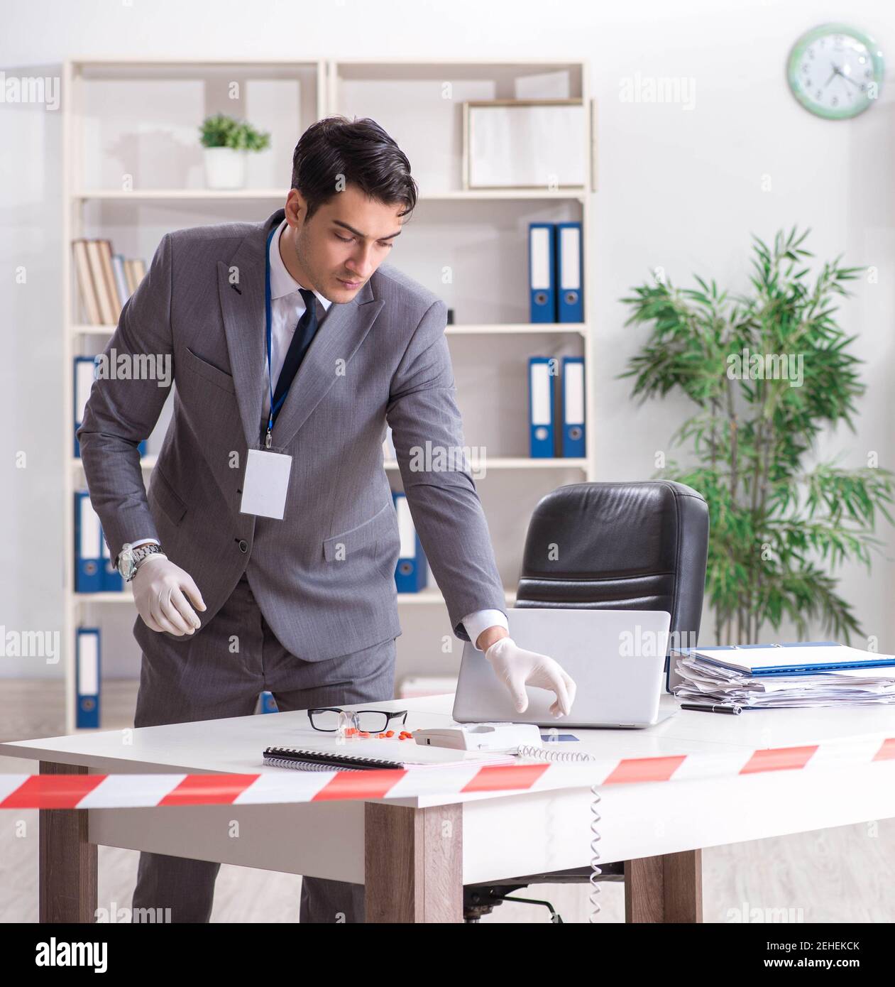 The forensics investigator at the scene of office crime Stock Photo - Alamy