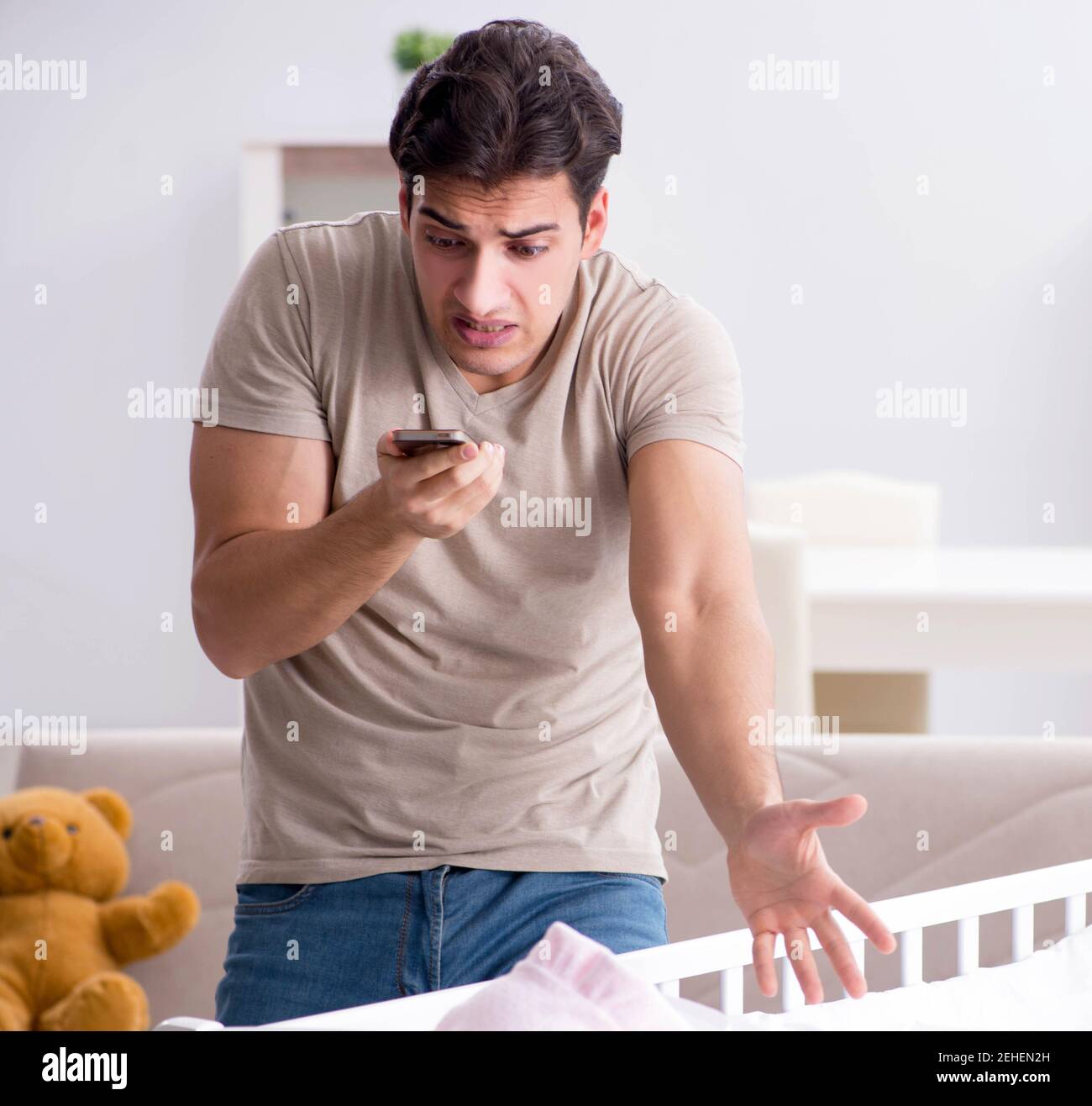The young father dad frustrated at crying baby Stock Photo - Alamy