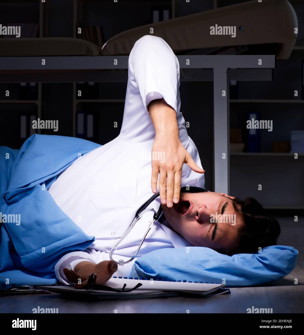 The doctor working night shift in hospital after long hours Stock Photo ...