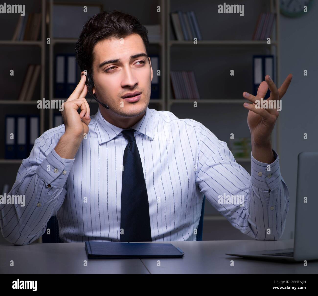 The call center operator talking to customer during night shift Stock ...