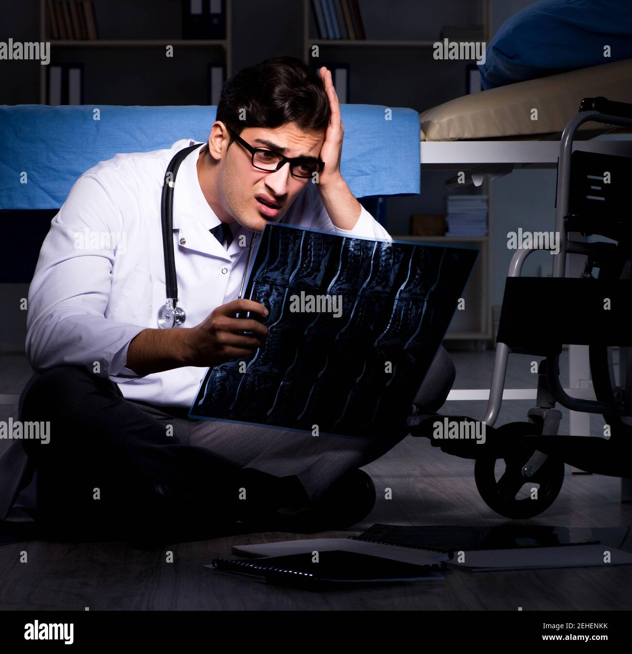 The doctor working night shift in hospital after long hours Stock Photo ...