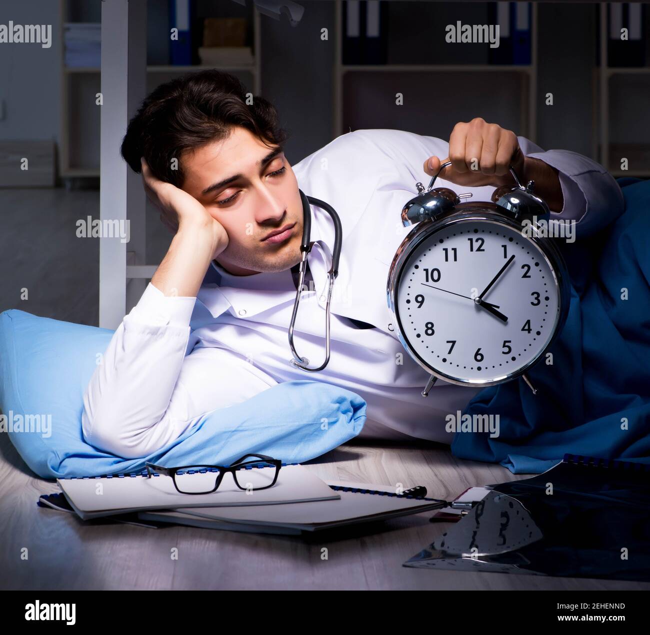 The doctor working night shift in hospital after long hours Stock Photo ...