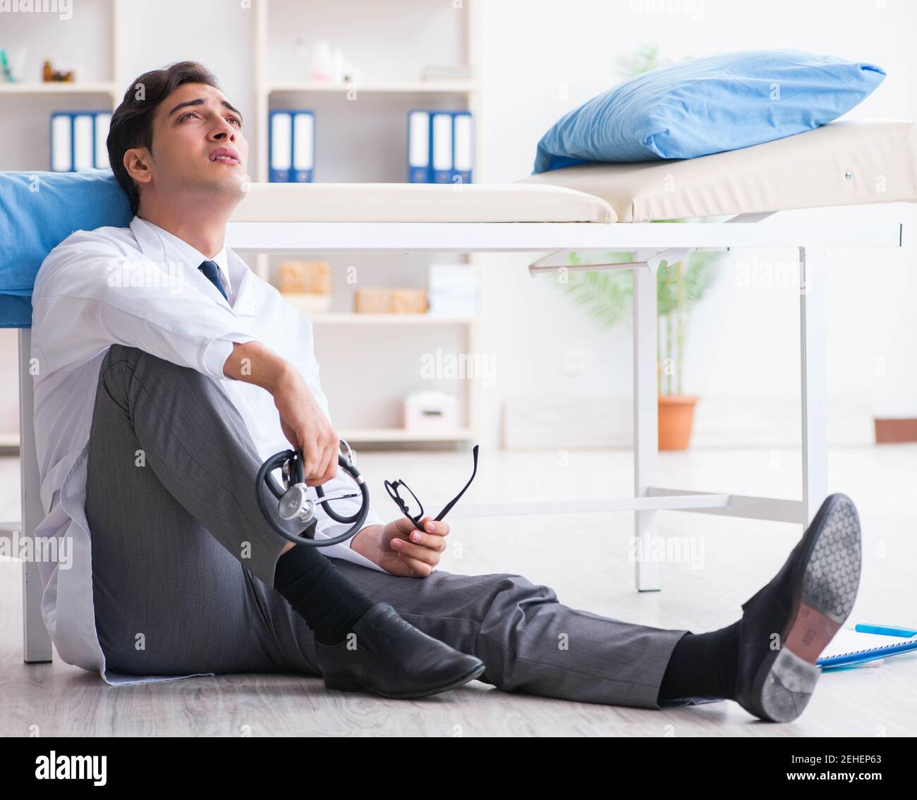 The doctor sitting on the floor in hospital Stock Photo - Alamy