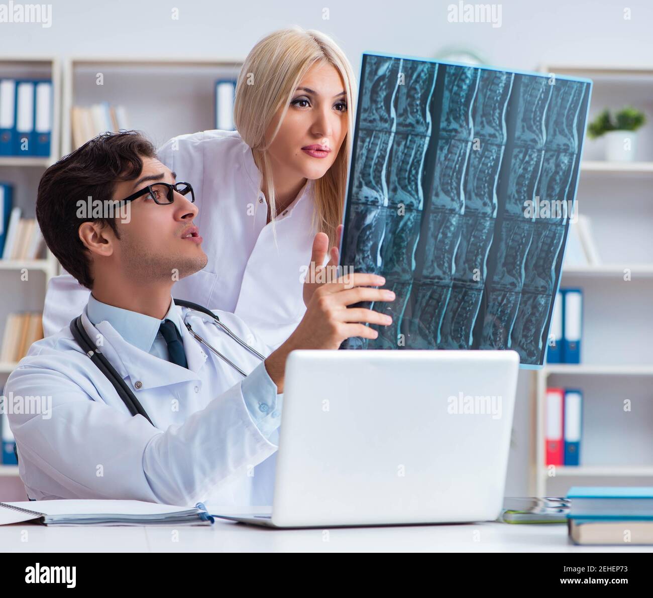 The two doctors examining x-ray images of patient for diagnosis Stock ...