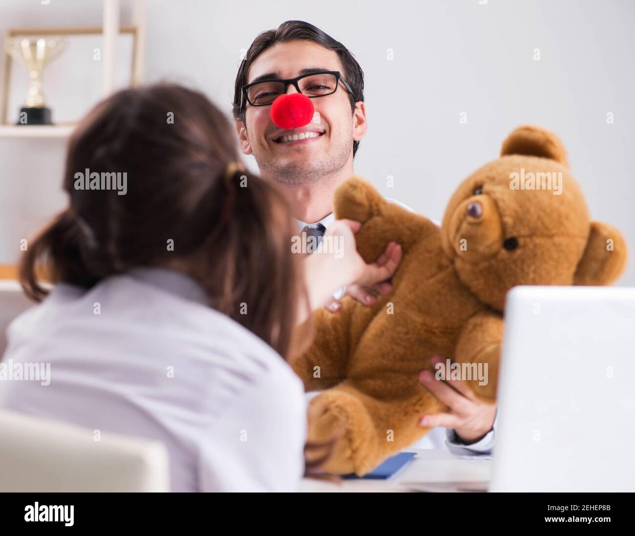 The funny pediatrician with little girl at regular check-up Stock Photo ...