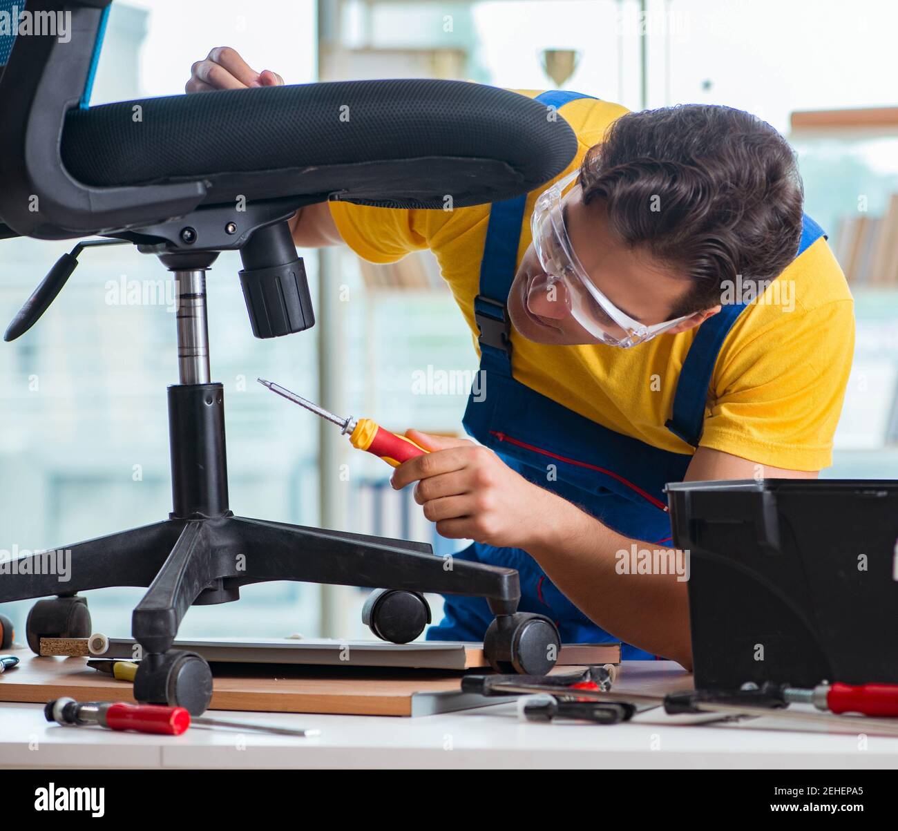 The furniture repairman working on repairing the chair Stock Photo - Alamy
