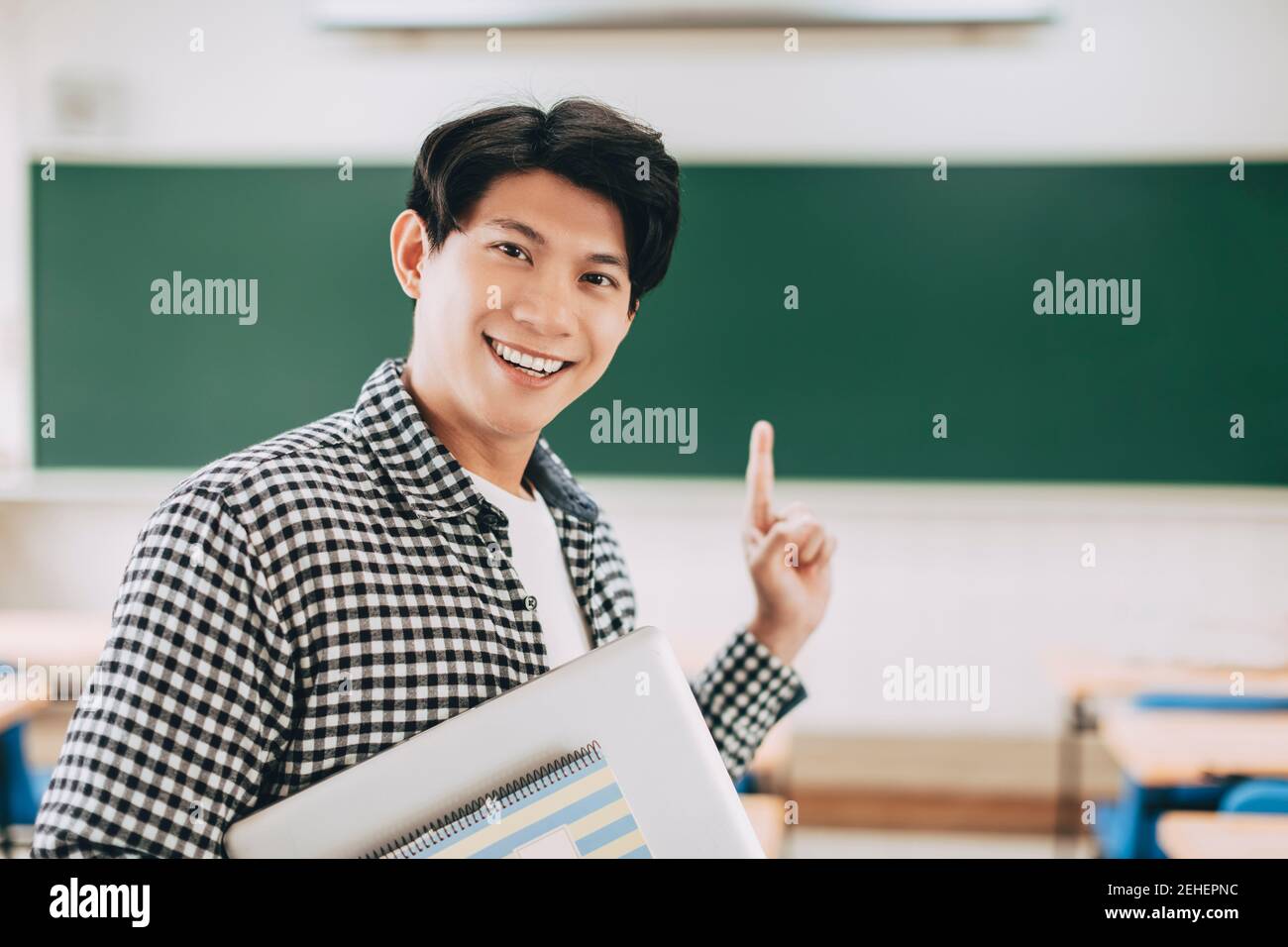 smiling student in university classroom hand pointing Stock Photo - Alamy
