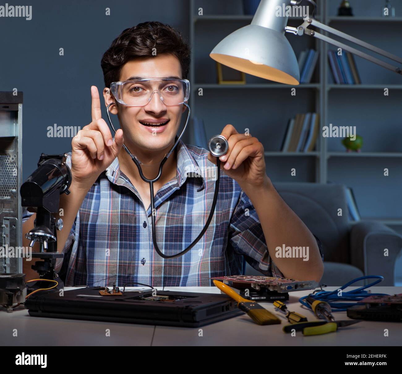 The computer repair concept with man inspecting with stethoscope Stock ...