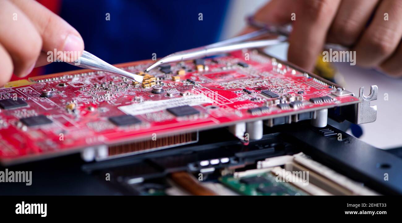Repairman working in technical support fixing computer laptop ...