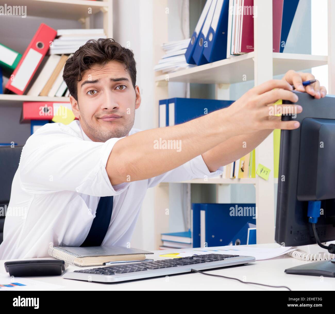 Businessman working in the office with piles of books and papers doing ...
