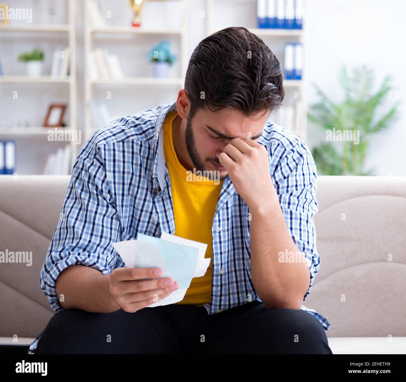 The man angry at bills he needs to pay Stock Photo - Alamy
