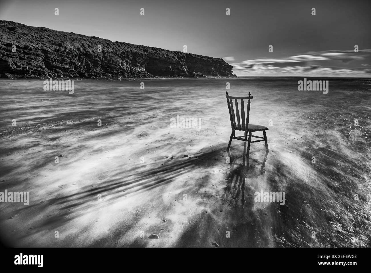 vintage antique chair tucked into the water of an Irish beach ...