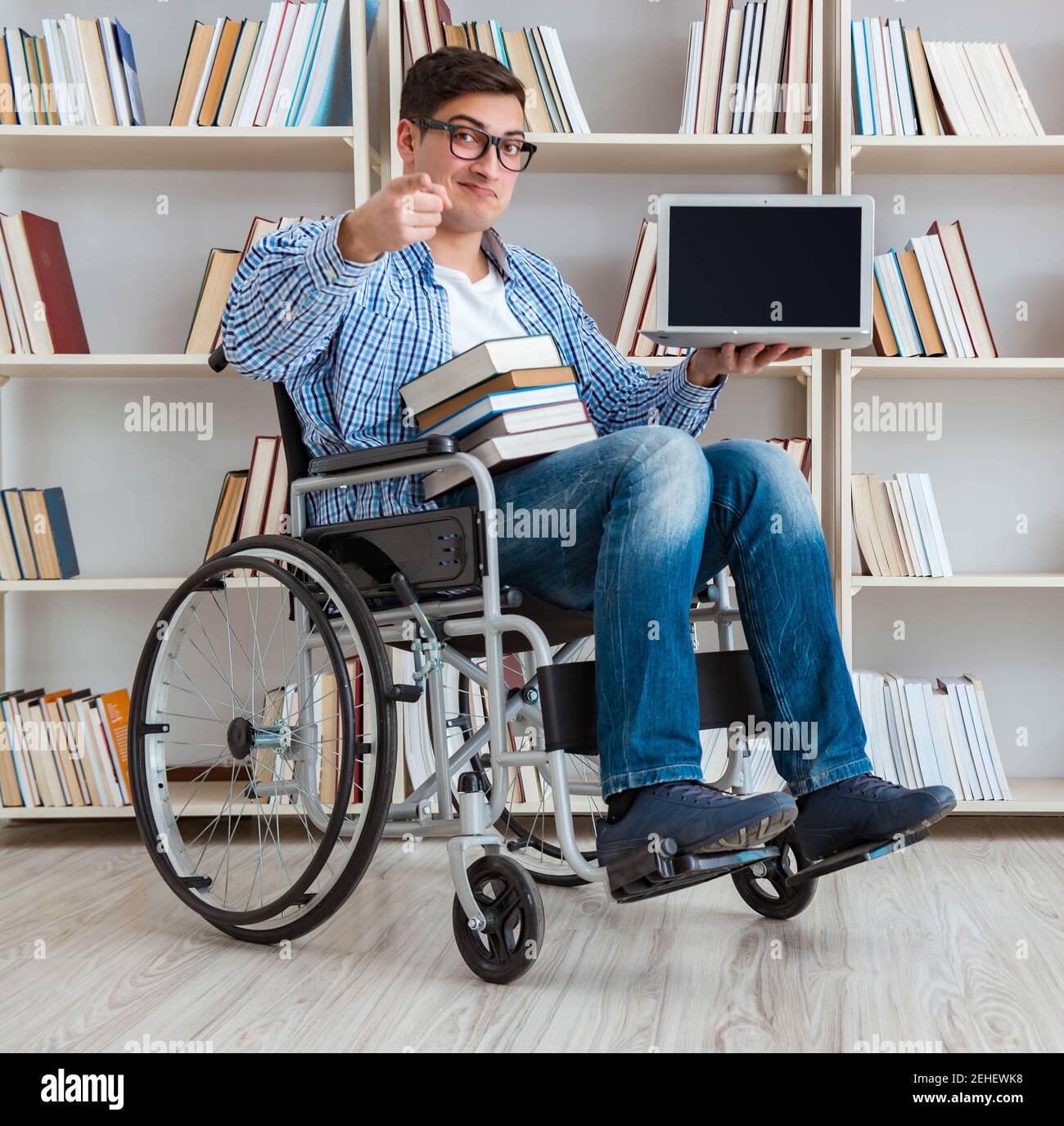The disabled student studying in the library Stock Photo - Alamy