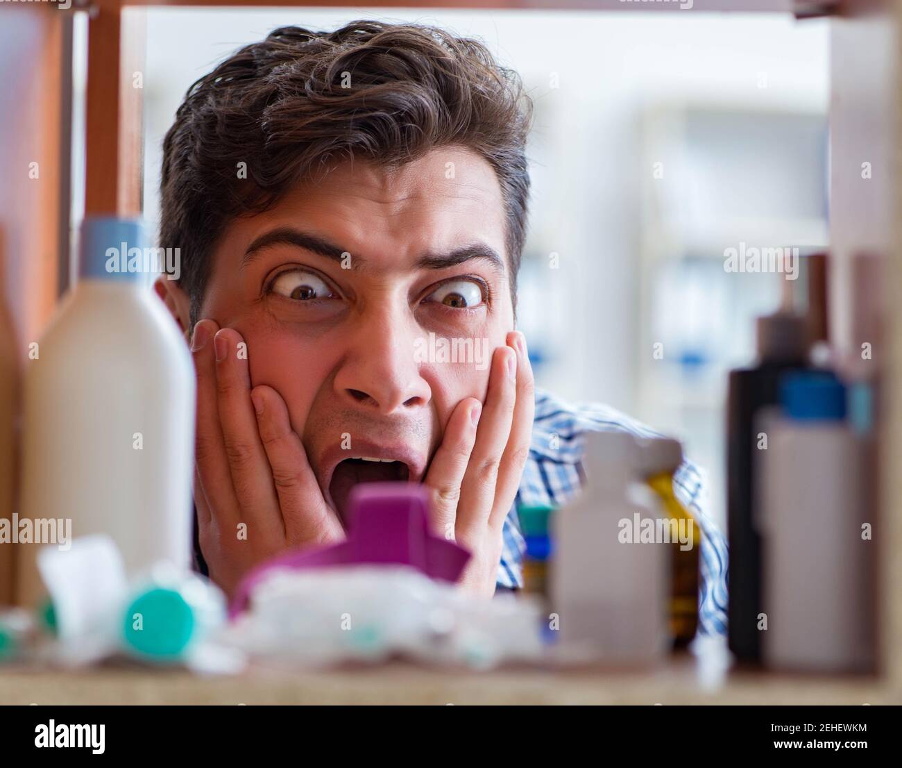The sick ill man looking for medicines at farmacy shelf Stock Photo - Alamy