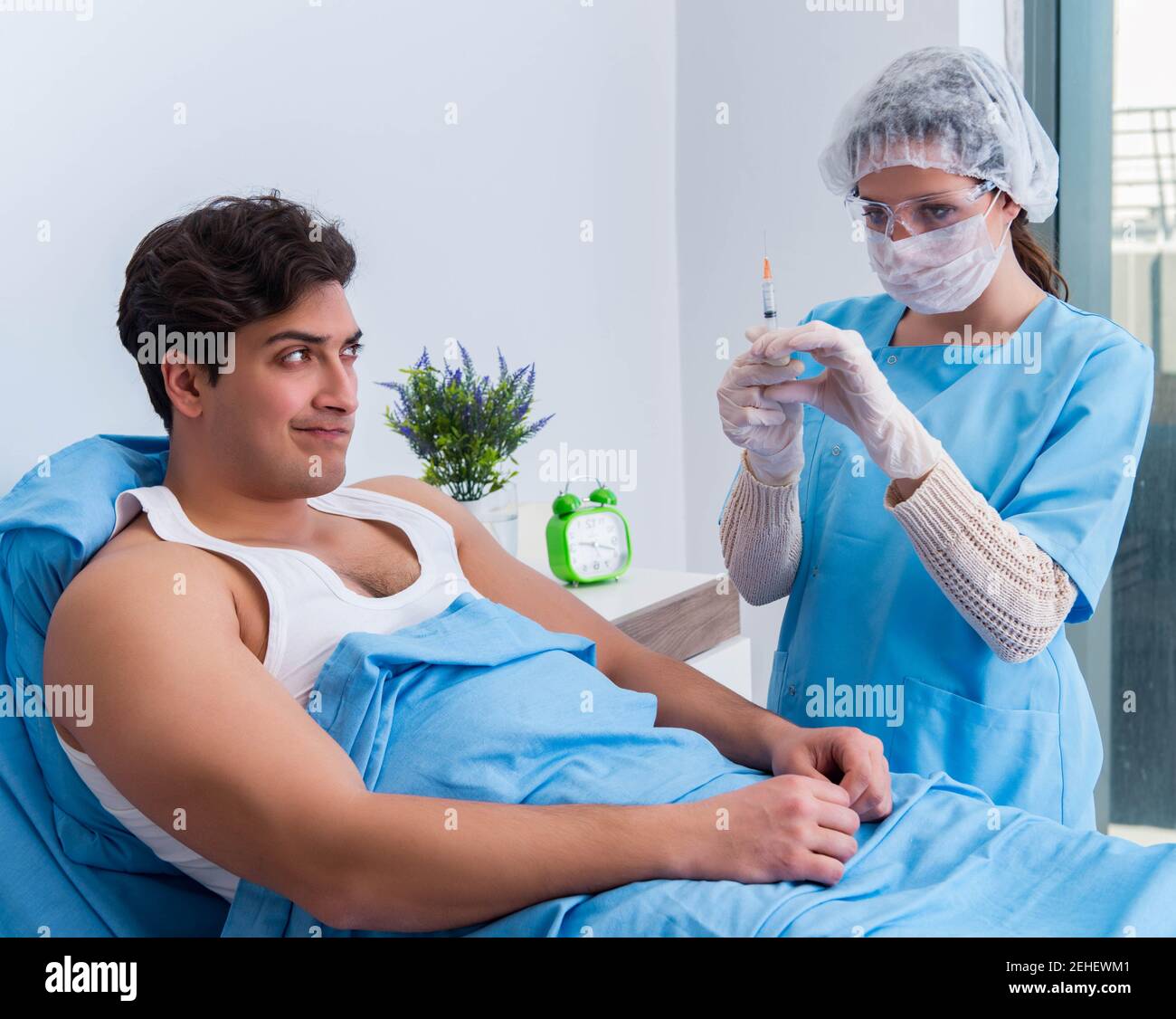 The doctor doing medical injection in hospital room Stock Photo - Alamy