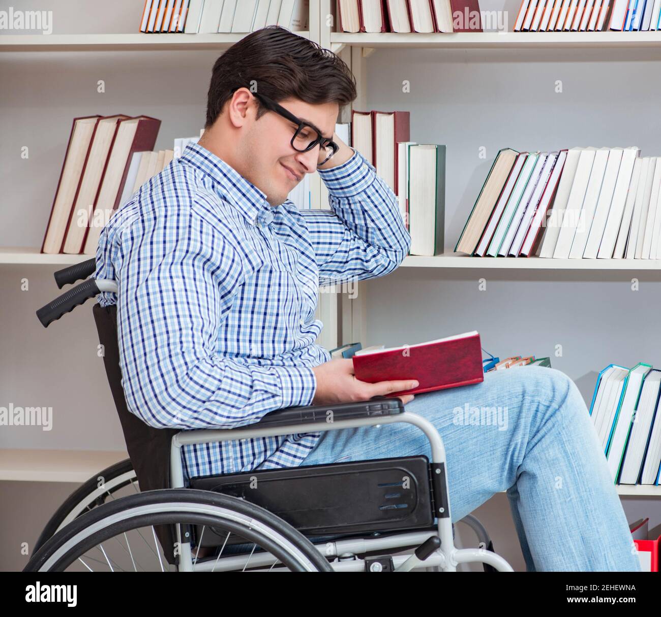 The disabled student studying in the library Stock Photo - Alamy