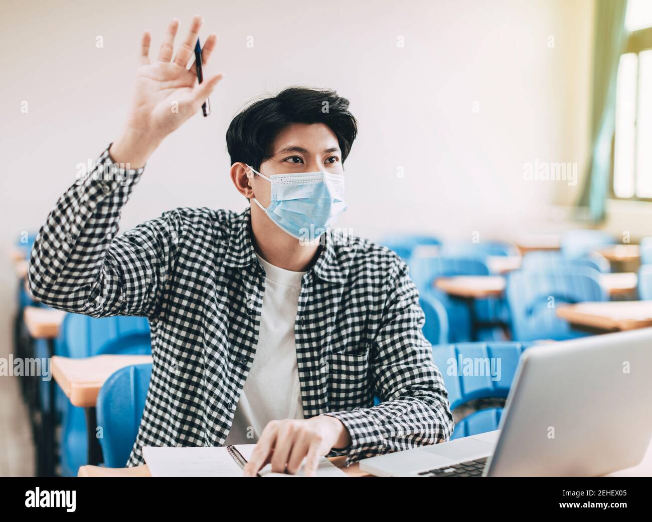 young student wearing face mask and studying in classroom Stock Photo ...