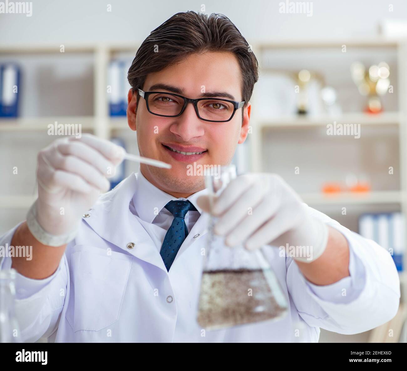 Young researcher scientist doing a water test contamination experiment ...