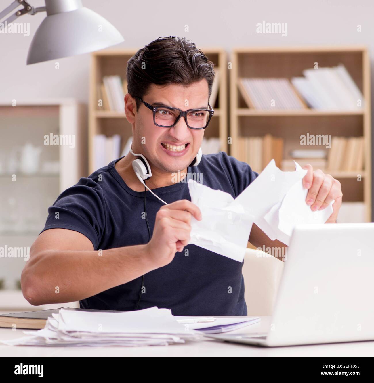 The angry man tearing apart his paperwork due to stress Stock Photo - Alamy