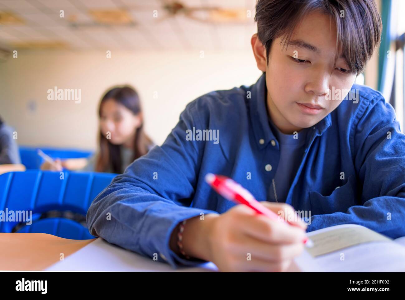 Teenager students studying in classroom Stock Photo - Alamy