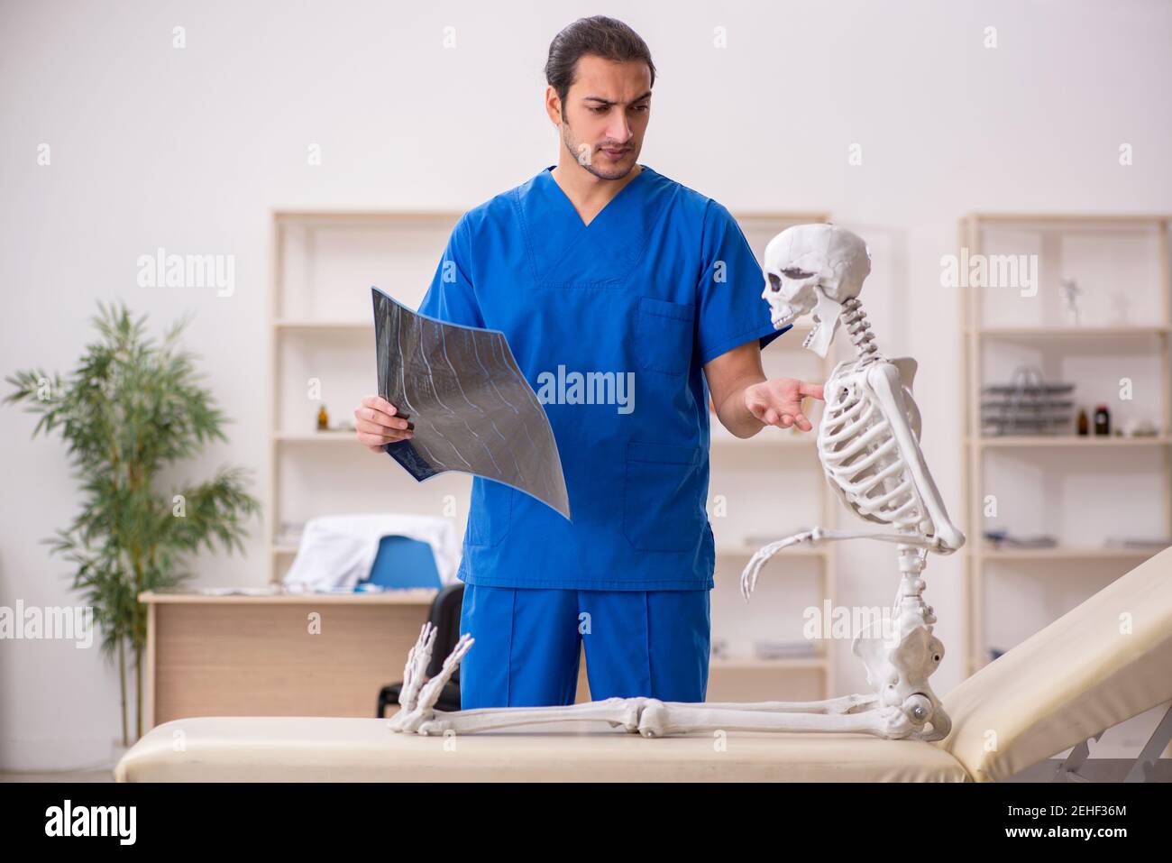 Young doctor radiologist and skeleton patient in the clinic Stock Photo ...