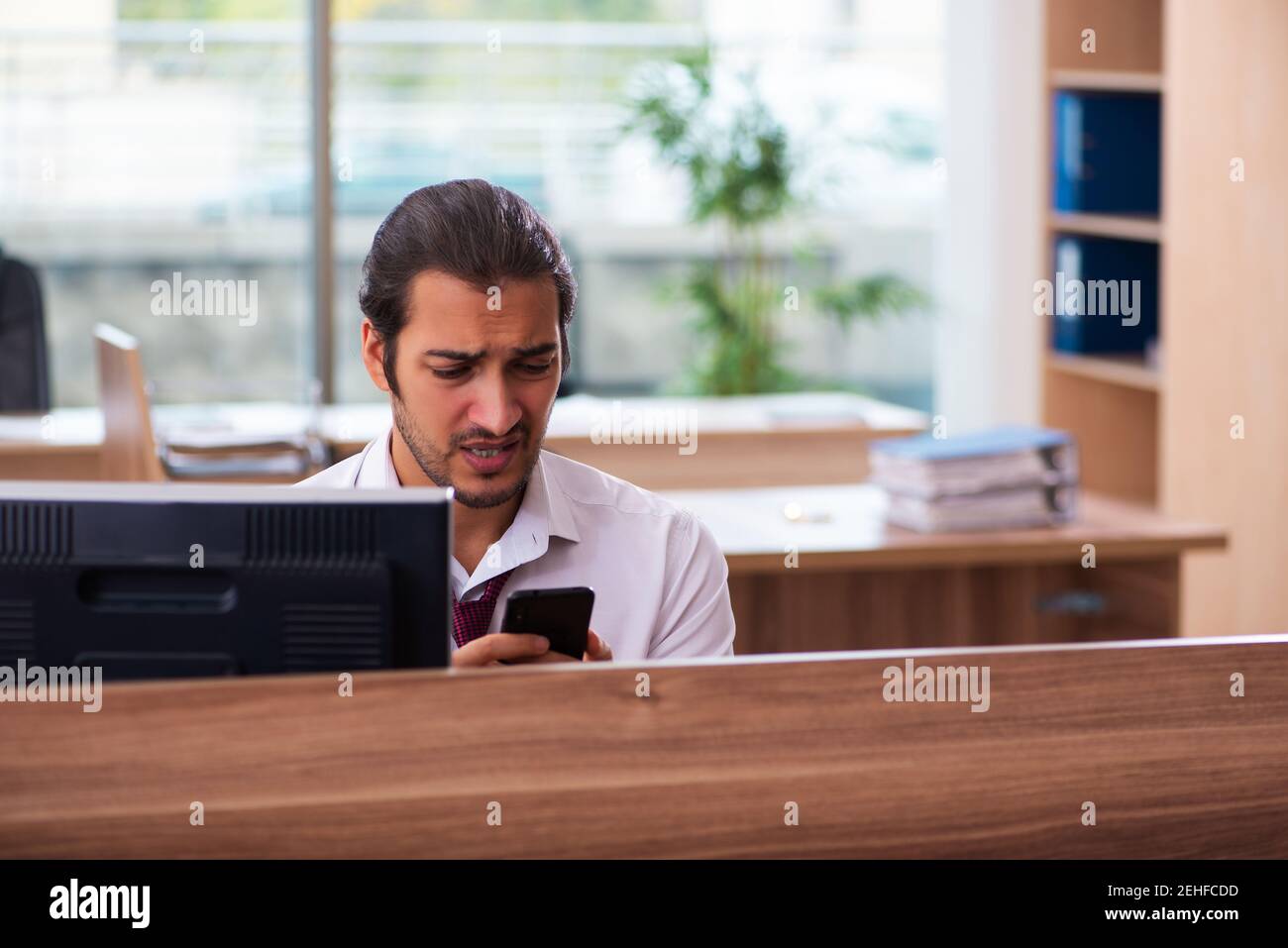 Young employee and too many work in the office Stock Photo - Alamy