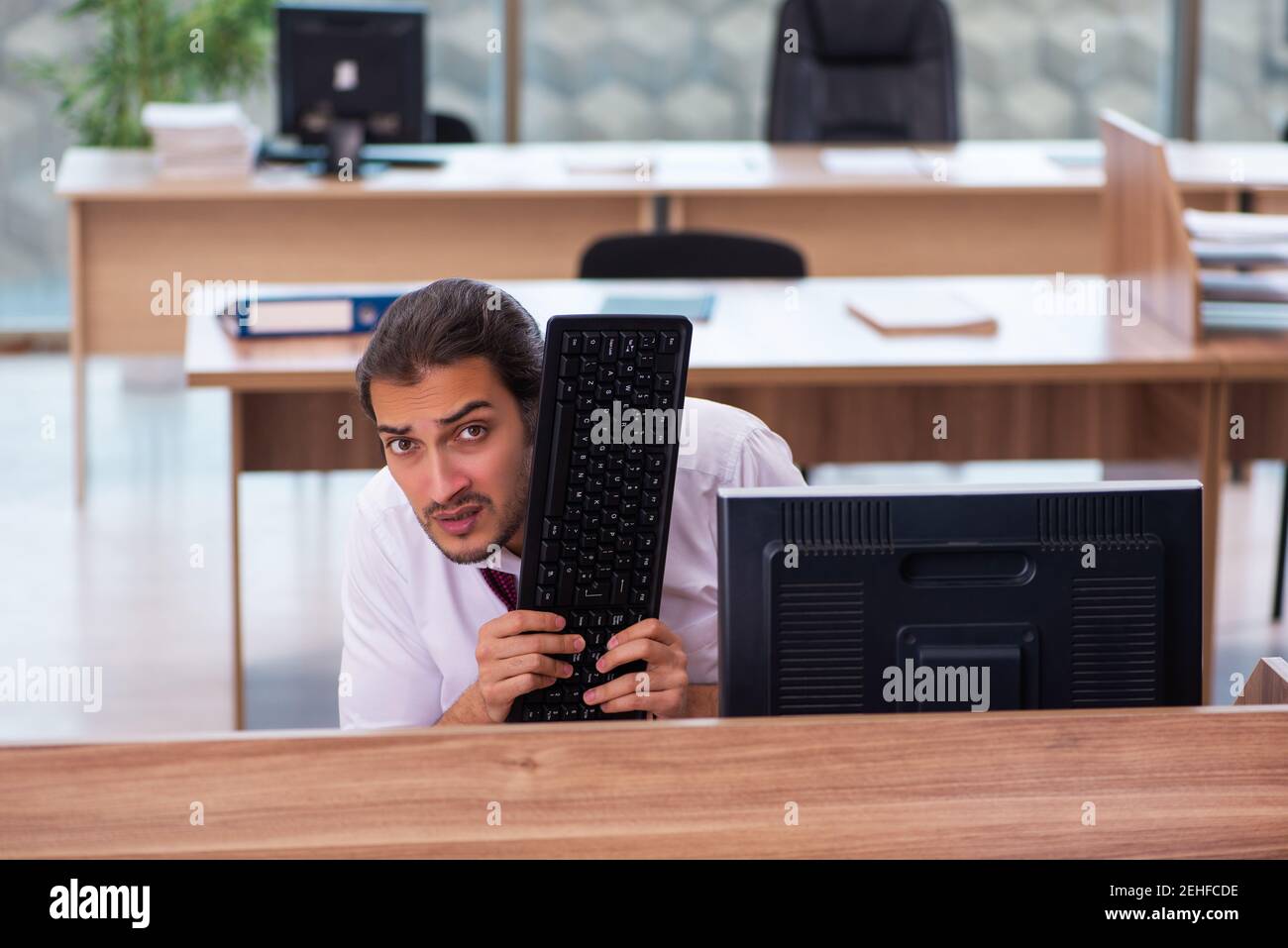 Young employee and too many work in the office Stock Photo - Alamy
