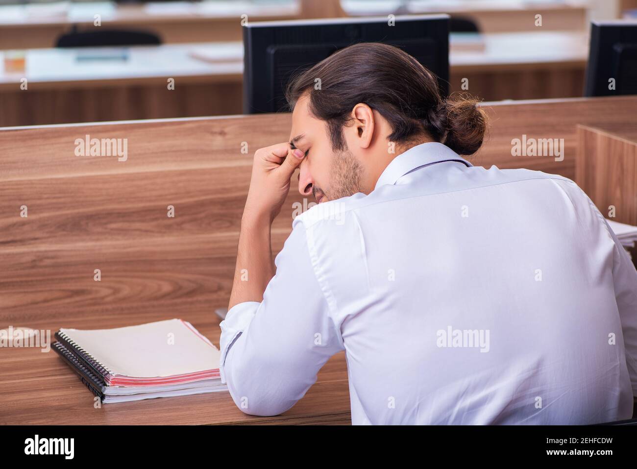 Young employee and too many work in the office Stock Photo - Alamy