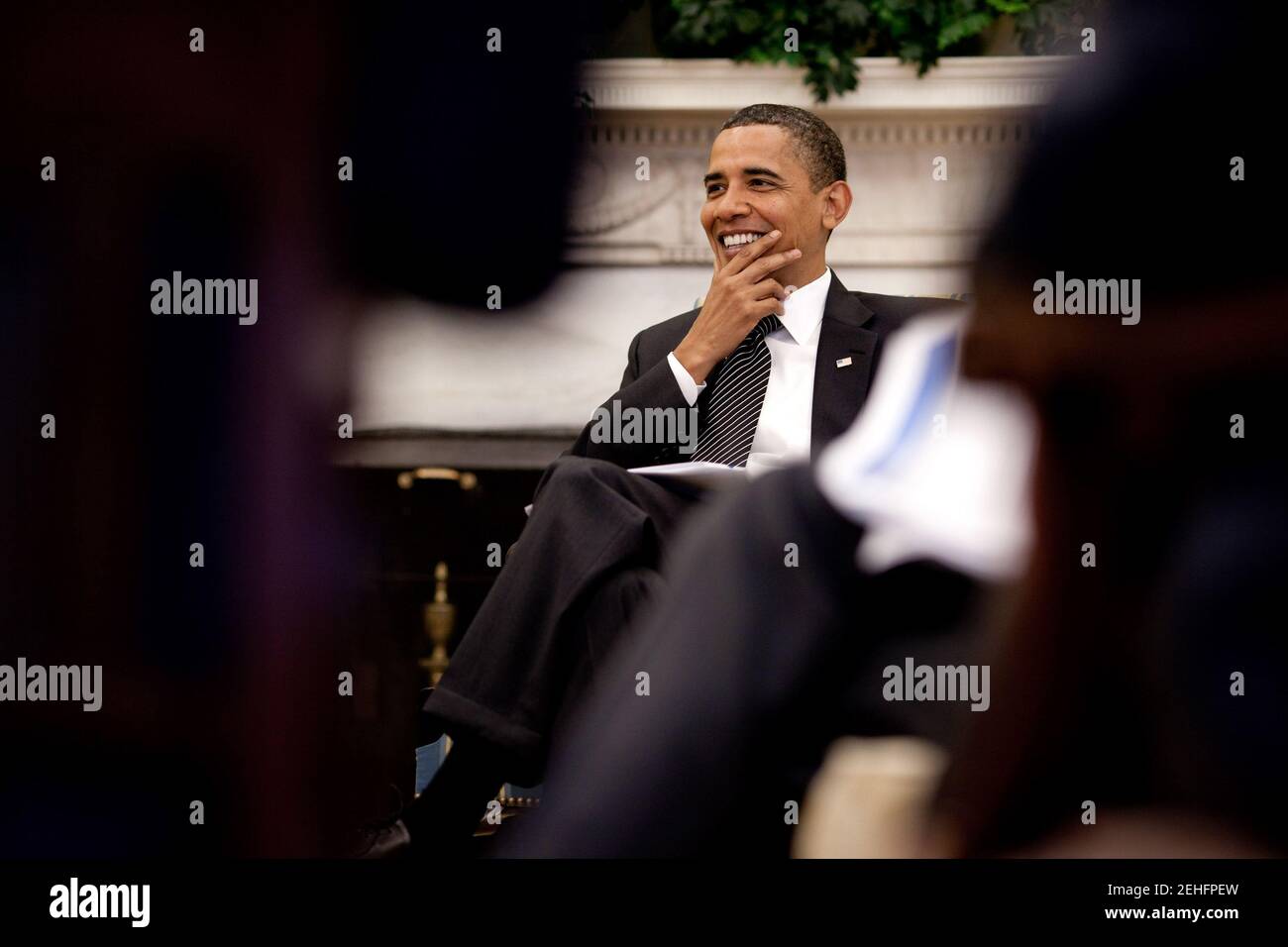 President Barack Obama grins during a morning meeting with Senior Staff ...