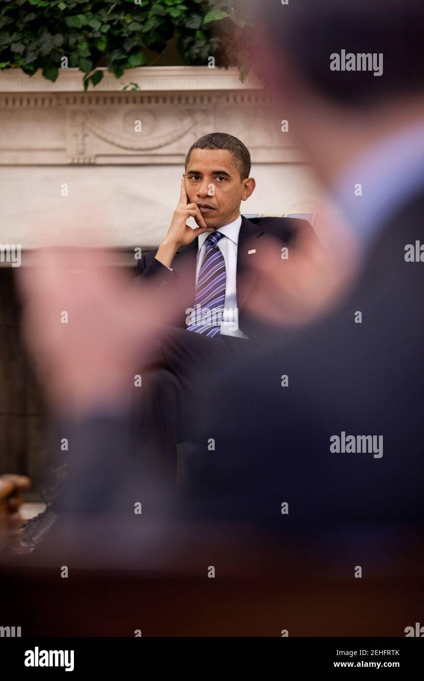 President Barack Obama listens to a point being made in a meeting with ...