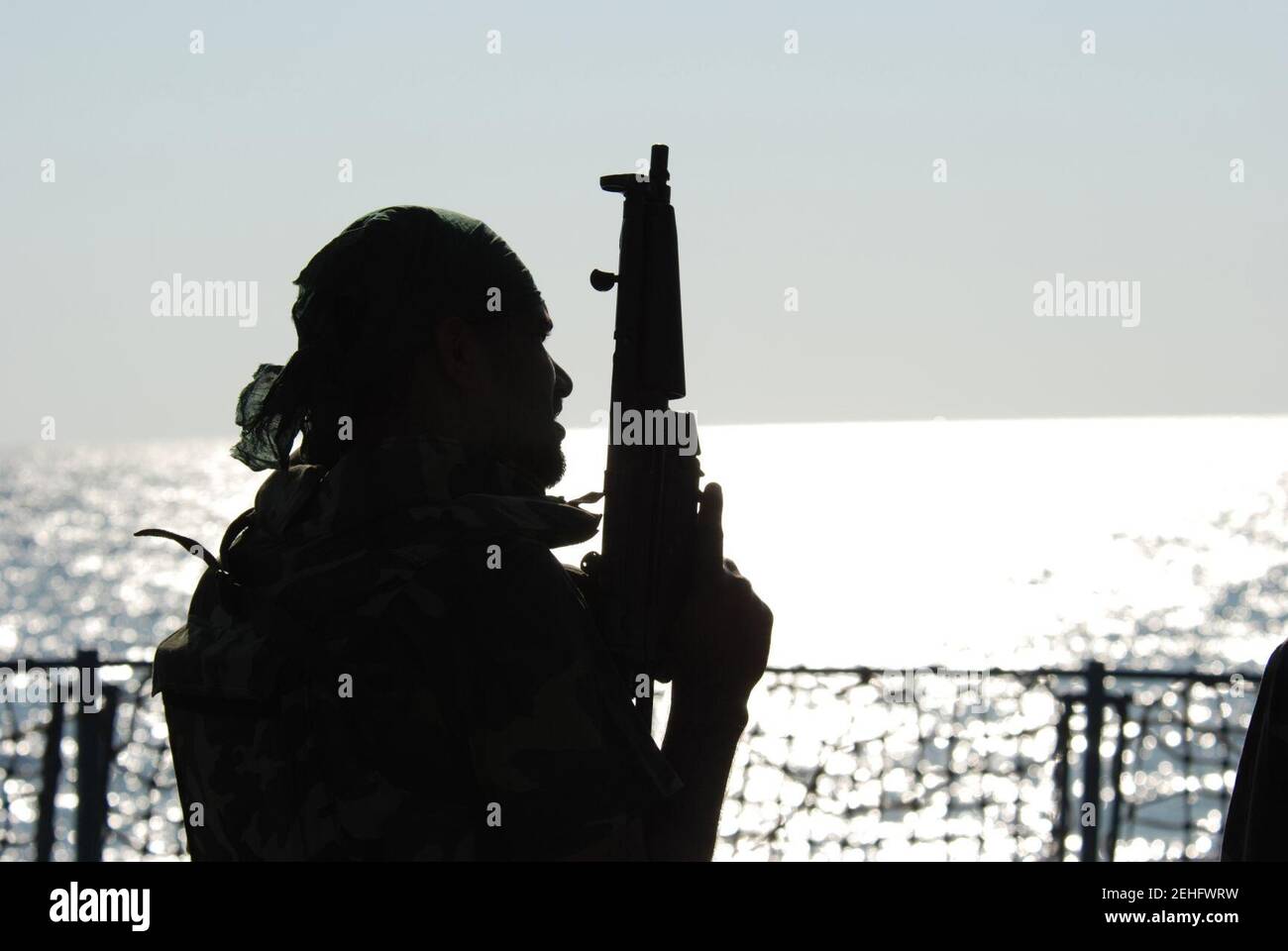 Pakistan Navy Special Service Group member silhouetted aboard Pakistan ...