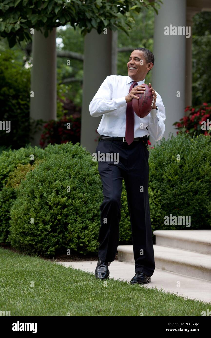 President Barack Obama tosses a football with Personal Aide Reggie Love ...