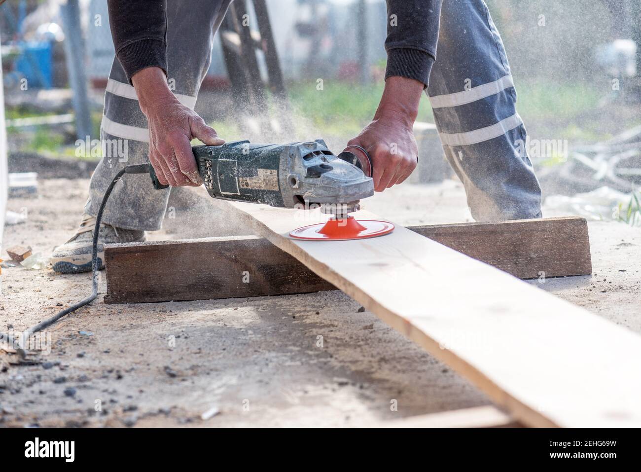 The man works with his hands, grinds the disk around for the grinder ...