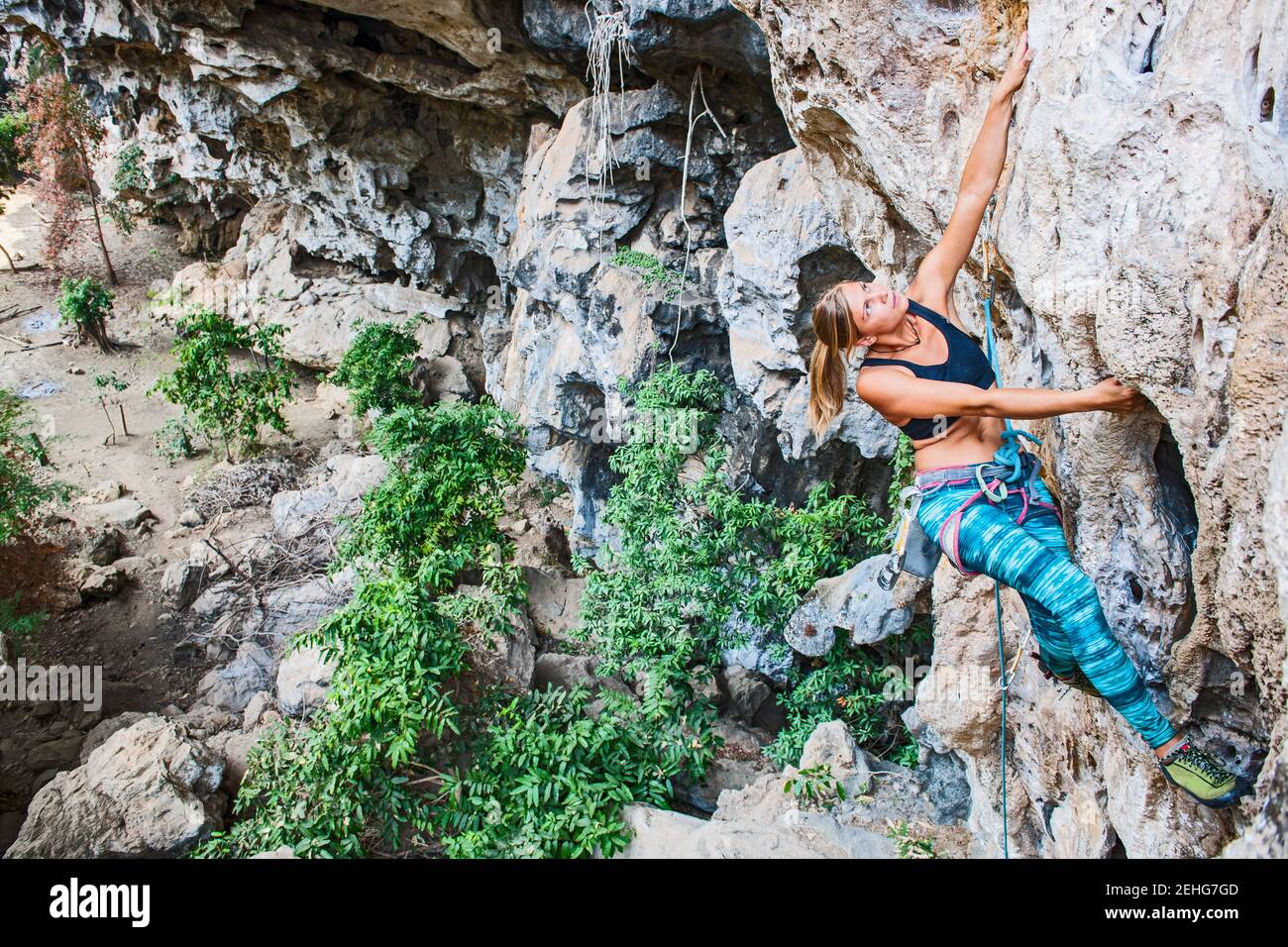 woman climbing steep limestone cliff in Laos Stock Photo - Alamy