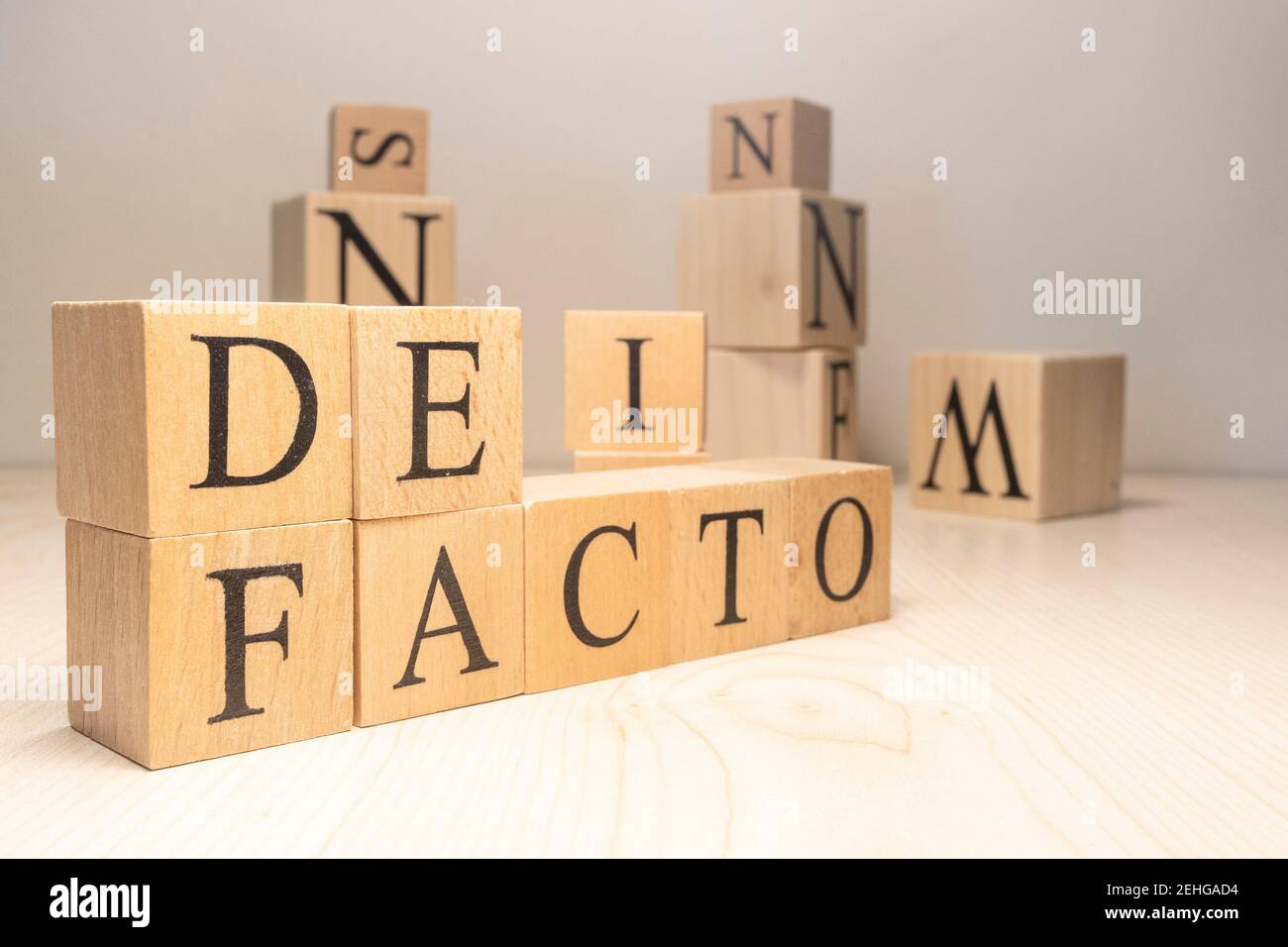 The Defacto Word is from wooden cubes. Terms of state government Stock ...