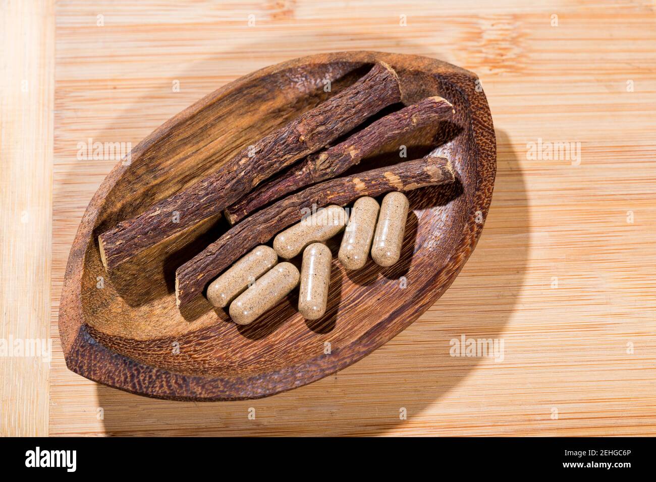 licorice root and tablets on black background Stock Photo - Alamy