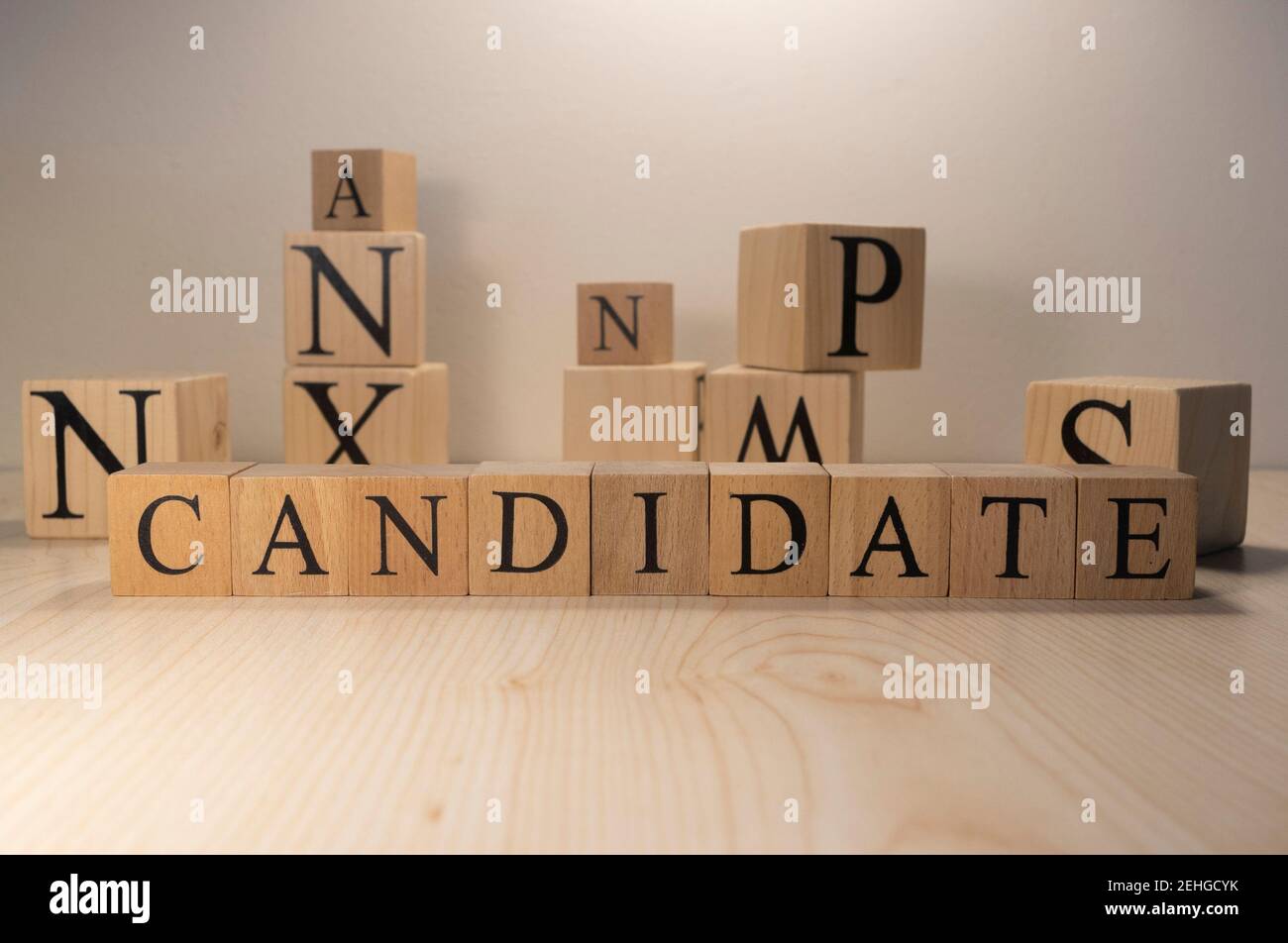 The word candidate is from wooden cubes. Background from wooden letters ...